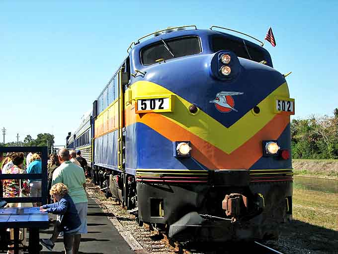 The vibrant locomotive stands ready for departure, its blue and yellow livery promising an evening of vintage charm and modern mystery.