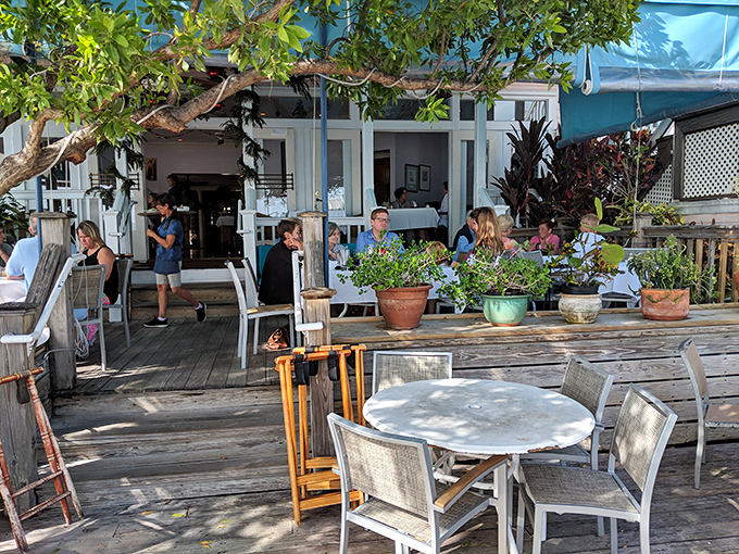 The outdoor deck where memories are made between bites. Those potted plants have witnessed more marriage proposals than a jewelry store.