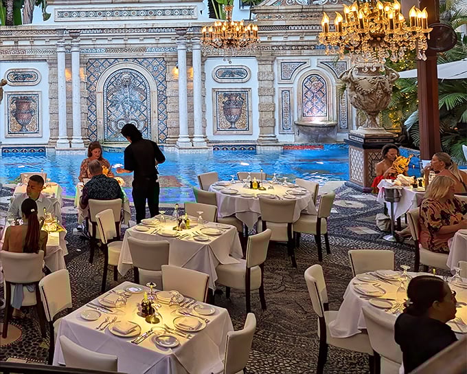 Attentive staff prepare for an evening of culinary magic, where every table setting becomes the stage for gastronomic memories.