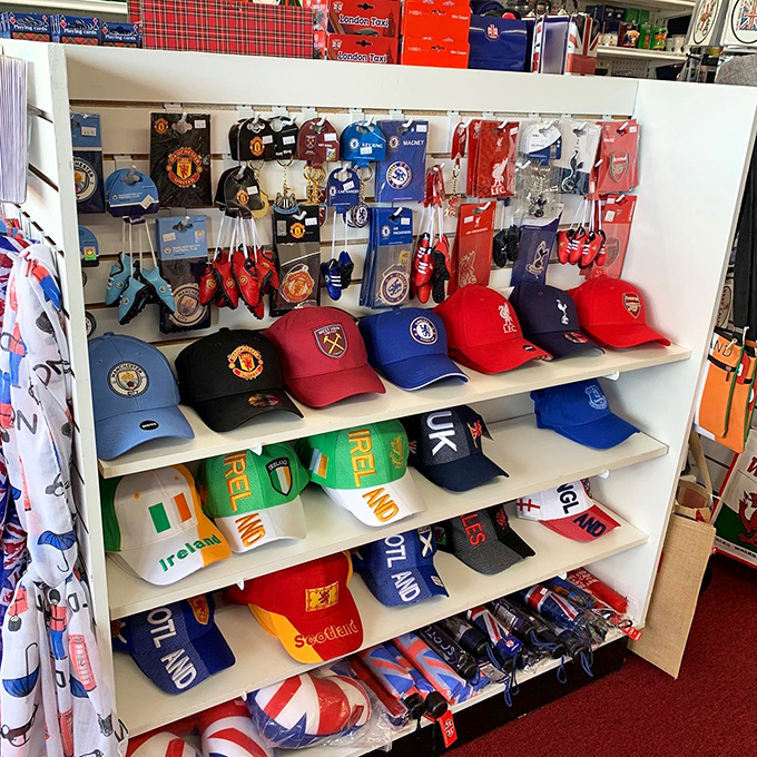 Football (never "soccer" here) merchandise transforms fans' homes into miniature stadiums, with Manchester United and Liverpool colors battling for shelf space.