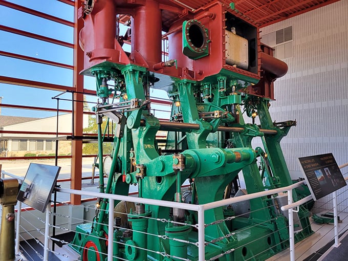 This massive marine engine once powered vessels through Great Lakes waters, its green paint hiding decades of industrial muscle.