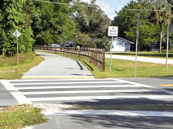 The wooden fence guides you along the path like a friendly neighbor pointing out the scenic route, keeping you on track without being pushy about it.