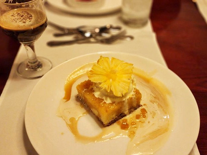The Cream Cheese Flan topped with pineapple proves that tropical flavors belong in fancy desserts, not just poolside drinks.