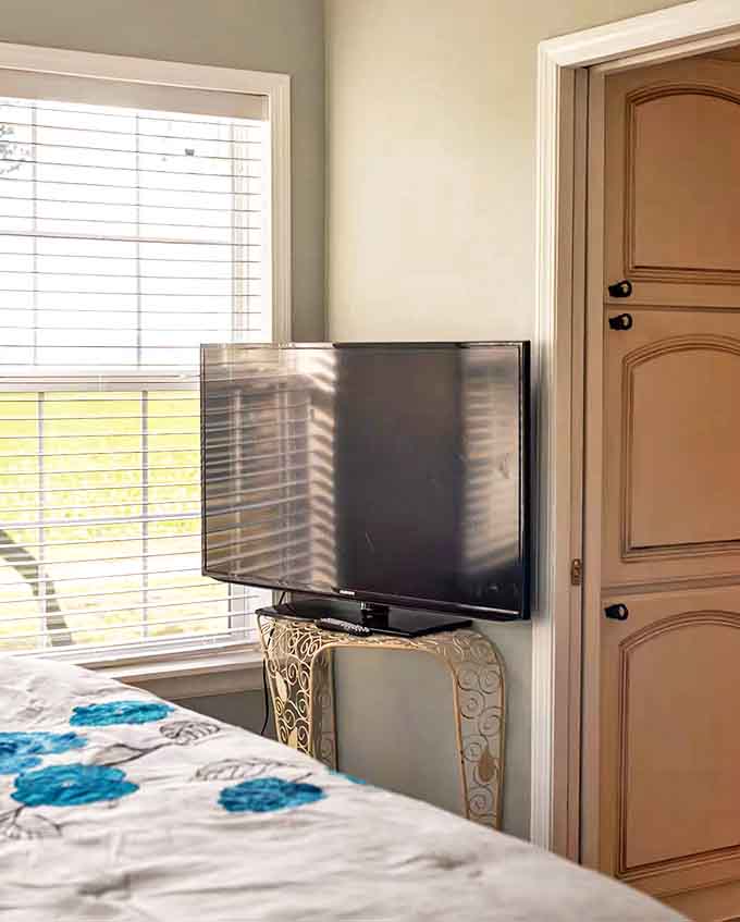 The strategically placed television might go unused when the sliding glass doors beside it frame a living landscape more captivating than any show.