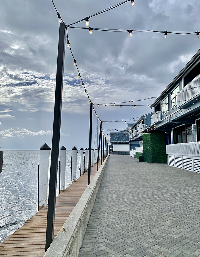String lights crisscross overhead, ready to transform the evening promenade into a magical walkway of twinkling stars and gentle sea breezes.