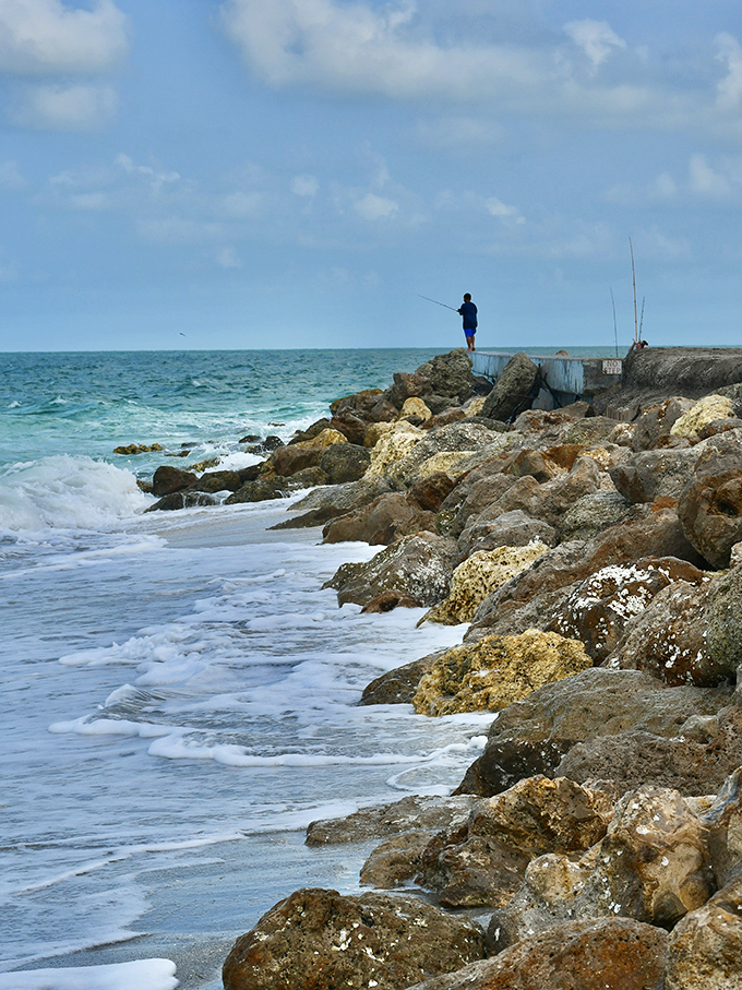 A solitary angler tests his luck against Boca Grande's legendary fishing grounds, where tarpon and snook have broken hearts and lines for decades.