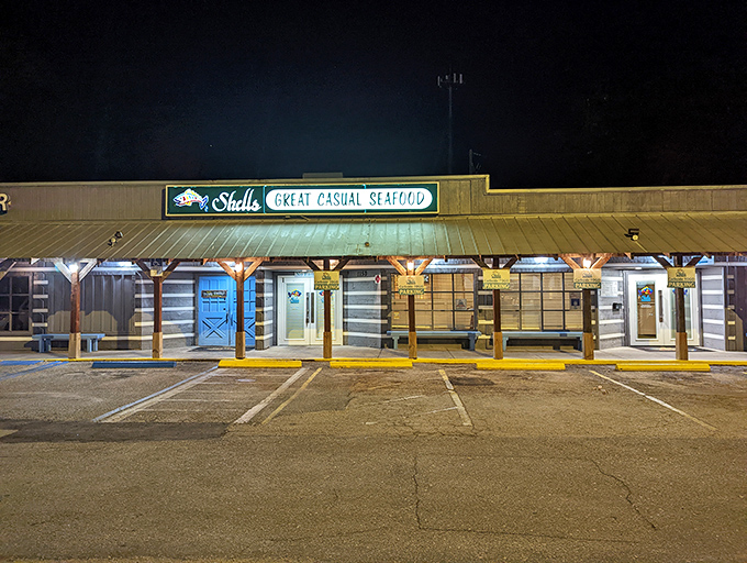 Shells' exterior at night has that "local secret" vibe &ndash; unassuming yet inviting, promising seafood treasures within its weathered wooden walls.