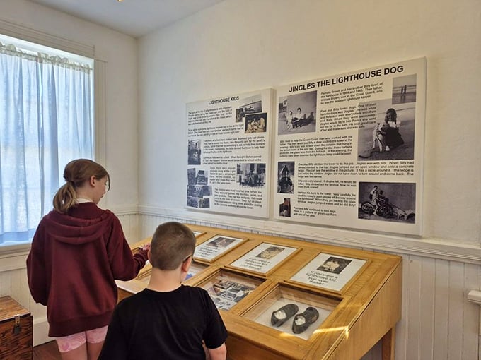 Children explore the educational displays, their curiosity ignited by tales of lighthouse keepers and the faithful dogs who kept them company.