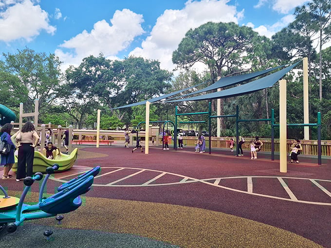 Colorful climbing challenges under Florida's blue skies &ndash; these red bars invite youngsters to swing, climb, and traverse like playground primates.