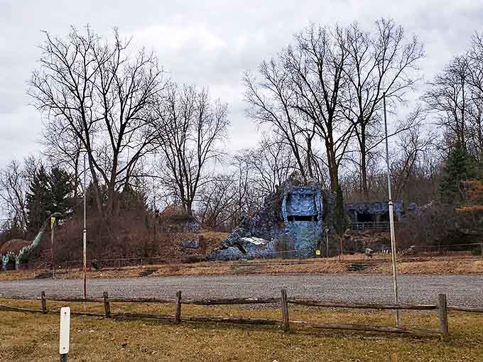 Winter reveals the park's stone structures, their outlines stark against the leafless trees and gray skies.