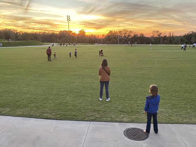As sunset paints the sky, families gather on the great lawn, proving that sometimes the best entertainment is simply open space.