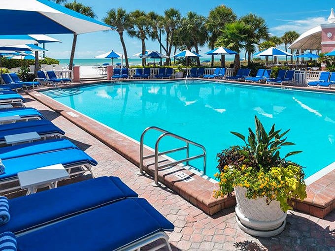 Pool perfection with an ocean view! Those blue loungers are calling your name louder than the ice cream truck on a summer day.