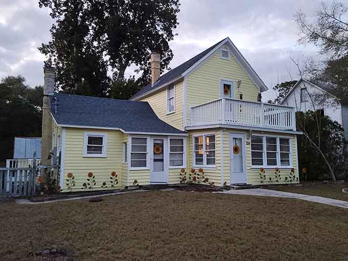 Cheerful yellow siding brightens this historic home, showing that spiritual communities can be both serious and delightfully colorful.