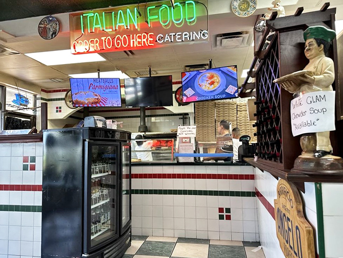 Where culinary magic happens behind glass&mdash;digital menus meet old-school Italian chef statues in this ordering command center.