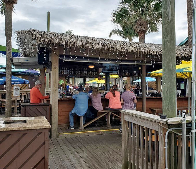 The tiki bar where tropical drinks flow freely and worries evaporate faster than morning dew in July.