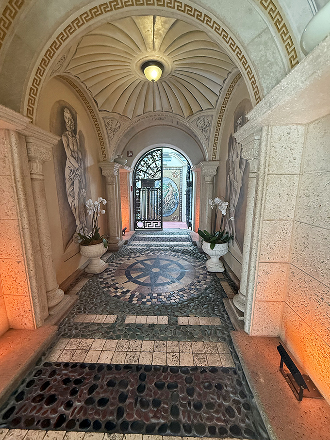 A mosaic-lined passage beckons guests deeper into the mansion, where architectural details whisper stories of glamorous days gone by.