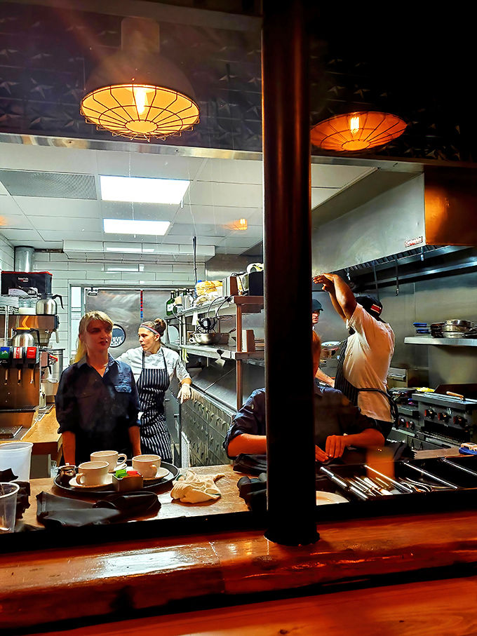Through the kitchen window, culinary artists orchestrate a symphony of sizzles and aromas, each plate a masterpiece of timing and technique.