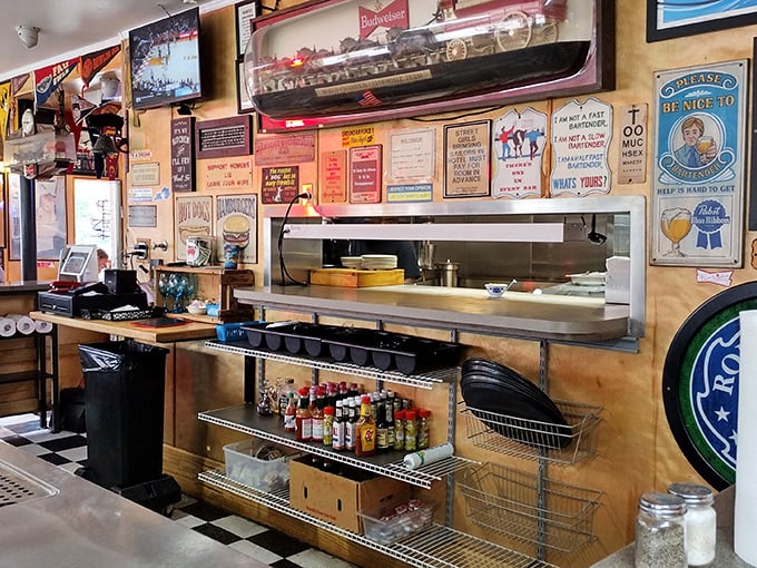 The open kitchen reveals the choreographed dance of short-order cooking, where decades of experience turn out plate after perfect plate.