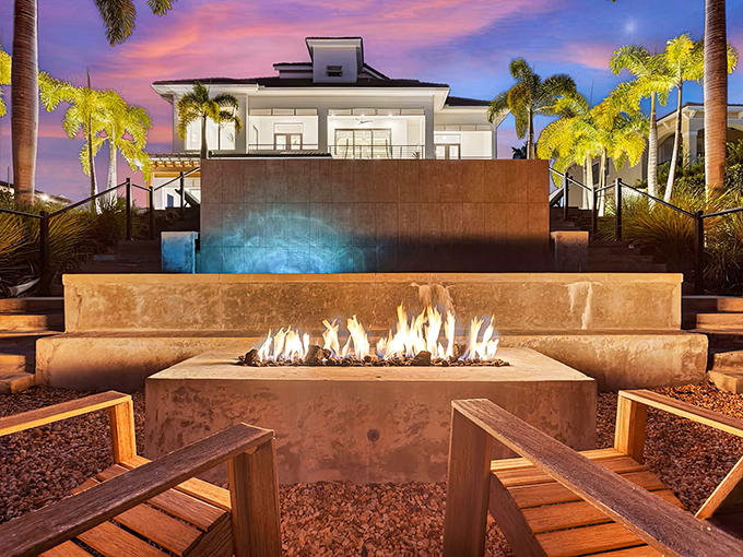 Evening magic unfolds around this fire feature where flames dance against the night and conversation flows as freely as the cascading water.