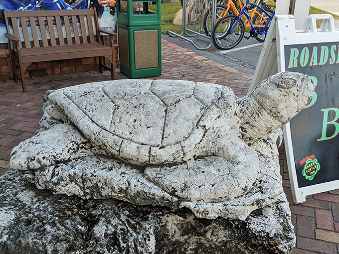 This weathered stone turtle stands guard outside &ndash; a silent sentinel who's seen decades of happy diners come and go.