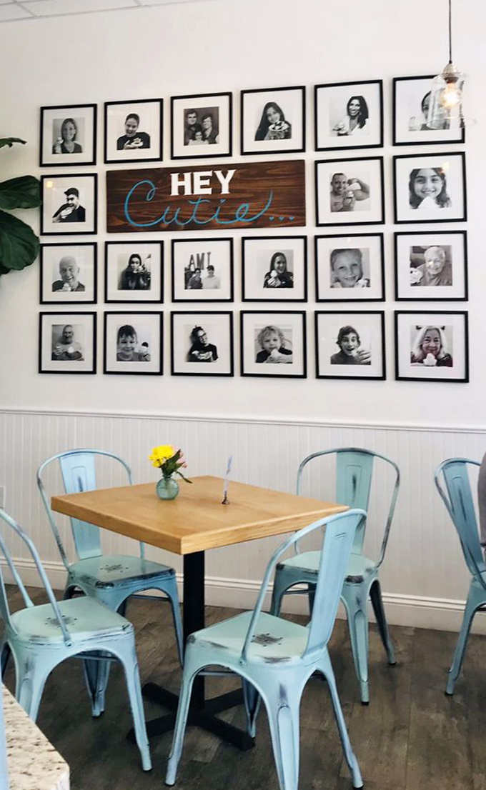 The charming "HEY Cutie" wall display surrounded by black and white photographs creates a homey, personal touch.