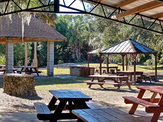 Picnic tables await beneath rustic pavilions, offering the perfect spot to refuel after an underwater journey through time.