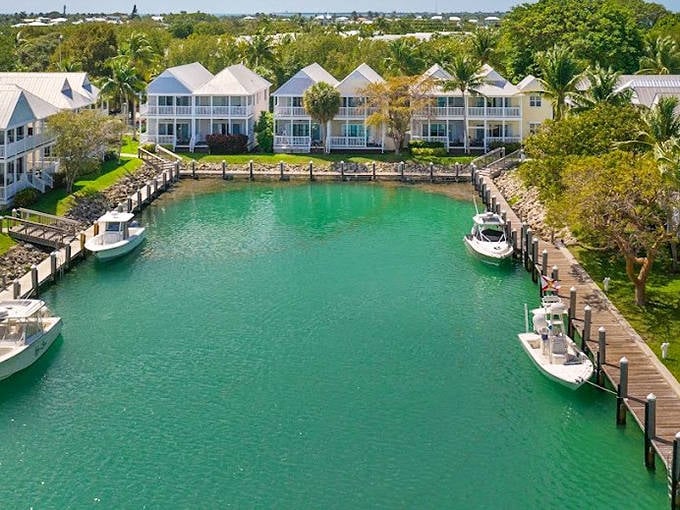 Harbor living at its finest! Hawks Cay Resort's waterfront villas surround a tranquil marina where boats bob gently in emerald waters.