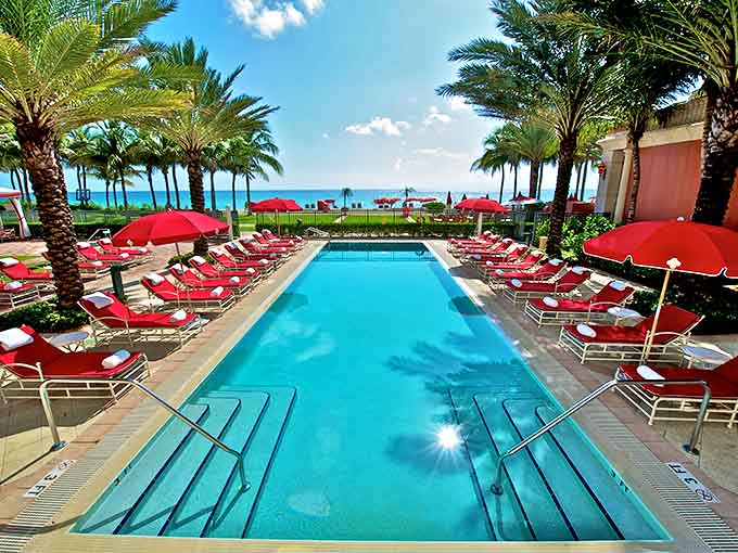 Palm trees line Acqualina's pristine beachfront, where luxury cabanas await couples seeking South Florida sunshine.