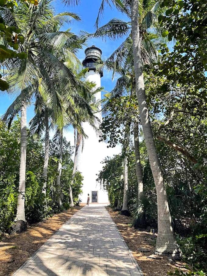 The historic lighthouse stands tall against blue sky, a beacon that has guided ships for nearly 200 years.