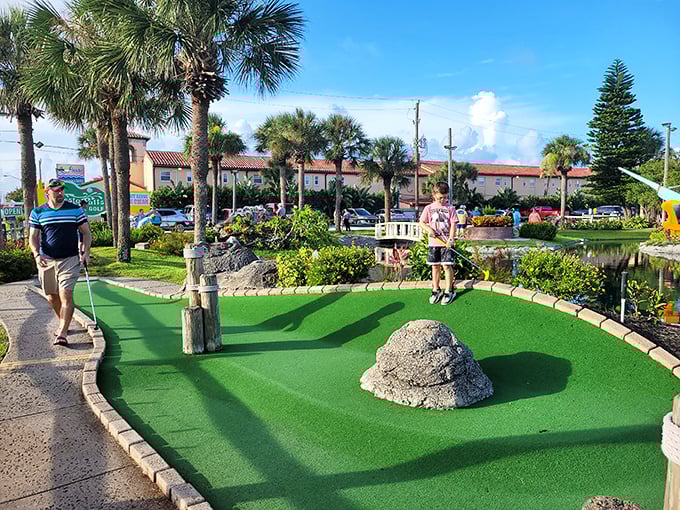 Family rivalries bloom alongside the tropical flowers as players discover that mini-golf brings out their competitive spirit faster than you can say "that's a gimme."