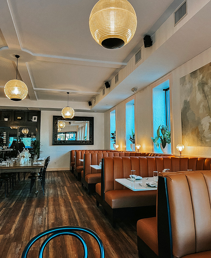 Golden pendant lights cast a flattering glow over leather booths where countless first dates have blossomed over shared plates of pasta.