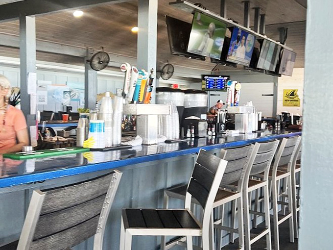 The sleek bar offers front-row seating to watch bartenders craft signature cocktails while TVs keep patrons updated on current races and games.