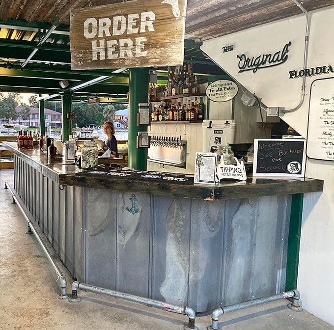 The bar beckons with its "ORDER HERE" sign and impressive lineup of spirits, promising refreshment with a view that beats any fancy cocktail lounge.