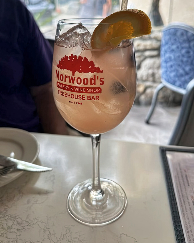 The Berry Blast Sangria arrives in Norwood's branded glassware, a vibrant, fruit-forward refresher that captures Florida sunshine in liquid form.