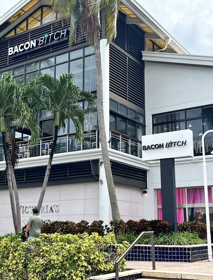The modern exterior stands out among South Beach's architecture, with palm trees providing that quintessential Miami framing.
