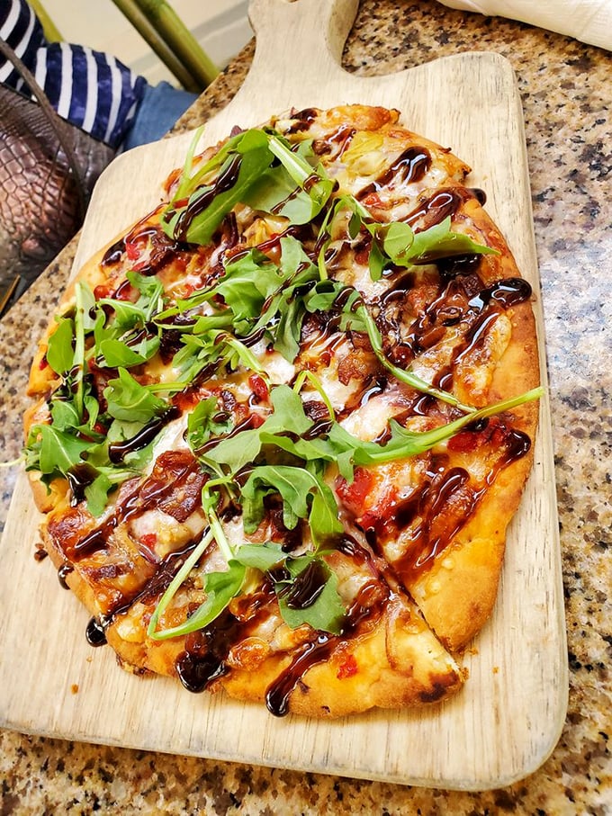 This flatbread isn't just pizza's sophisticated cousin&mdash;it's a canvas where arugula, cheese, and balsamic reduction create edible art.