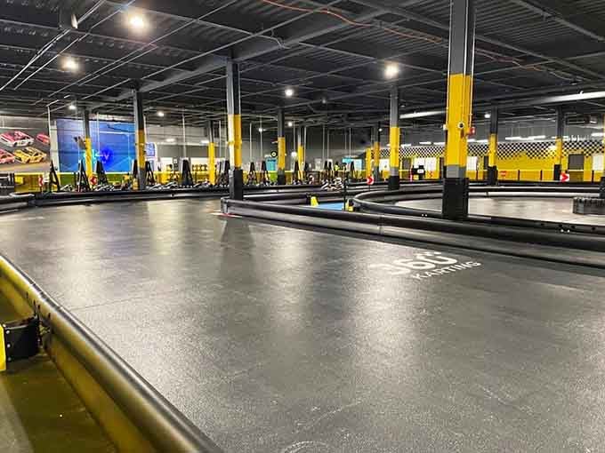 The go-kart track sprawls across the floor like a racing fan's fever dream, all curves and straightaways begging for speed.