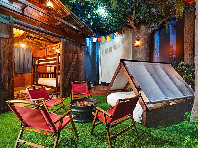 Glamping gets an upgrade with this outdoor tent setup where campfire stories happen on comfortable chairs under twinkling string lights.