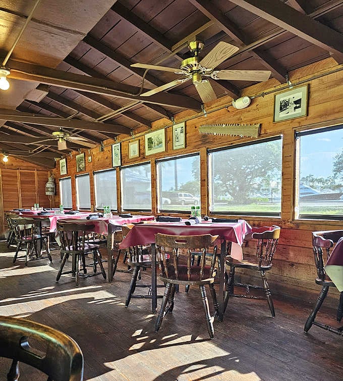 Another interior angle: Pink tablecloths brighten the rustic wooden interior, where ceiling fans lazily spin above chairs that have supported generations of seafood enthusiasts.