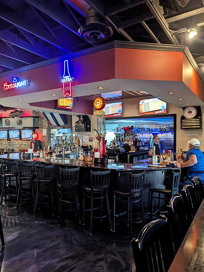 The well-stocked bar area, with its neon signs and multiple TVs, creates the perfect gathering spot for both locals and tourists.