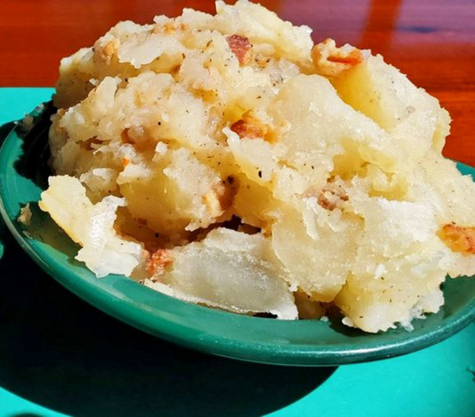 German potato salad that deserves its own fan club &ndash; warm, tangy, bacon-studded perfection that complements the smoky fish.
