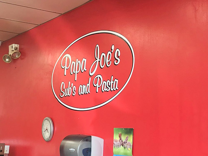 That logo on the red wall is like a beacon of deliciousness, guiding hungry souls to their destiny, one sub at a time.