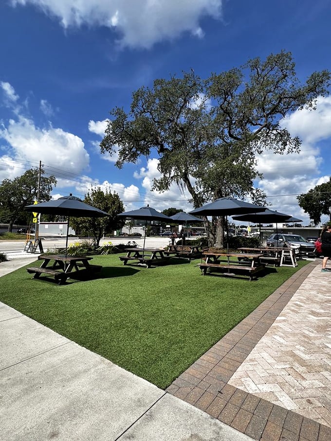 Outdoor dining under ancient oaks creates the perfect setting for savoring your market finds while soaking in Orlando's vibrant atmosphere.