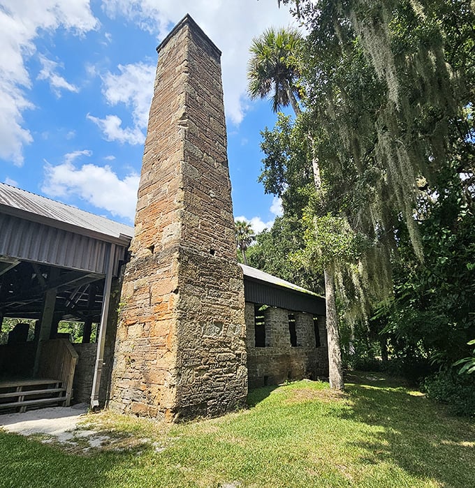 The towering brick chimney stands as a monument to Florida's industrial past, its weathered surface telling stories of the state's sugar-producing heritage.