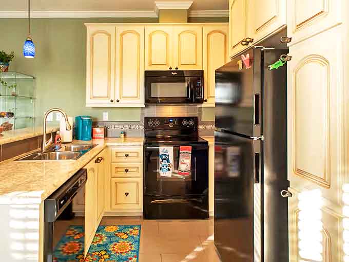 The kitchen's cream cabinetry and black appliances create a timeless backdrop for preparing meals with locally sourced ingredients.