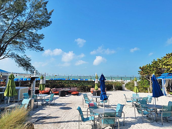 The outdoor dining area blends beach casual with culinary sophistication, where salt air seasons every meal and flip-flops are always appropriate footwear.