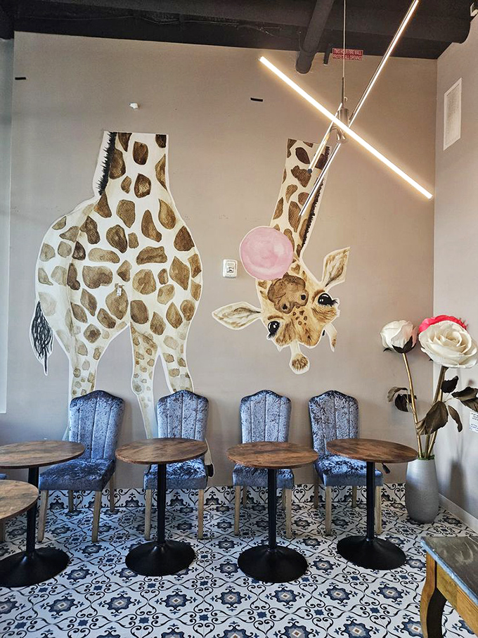 A giraffe mural watches over patrons with its bubble gum pink tongue extended, as if hoping to taste the coffee-scented air.