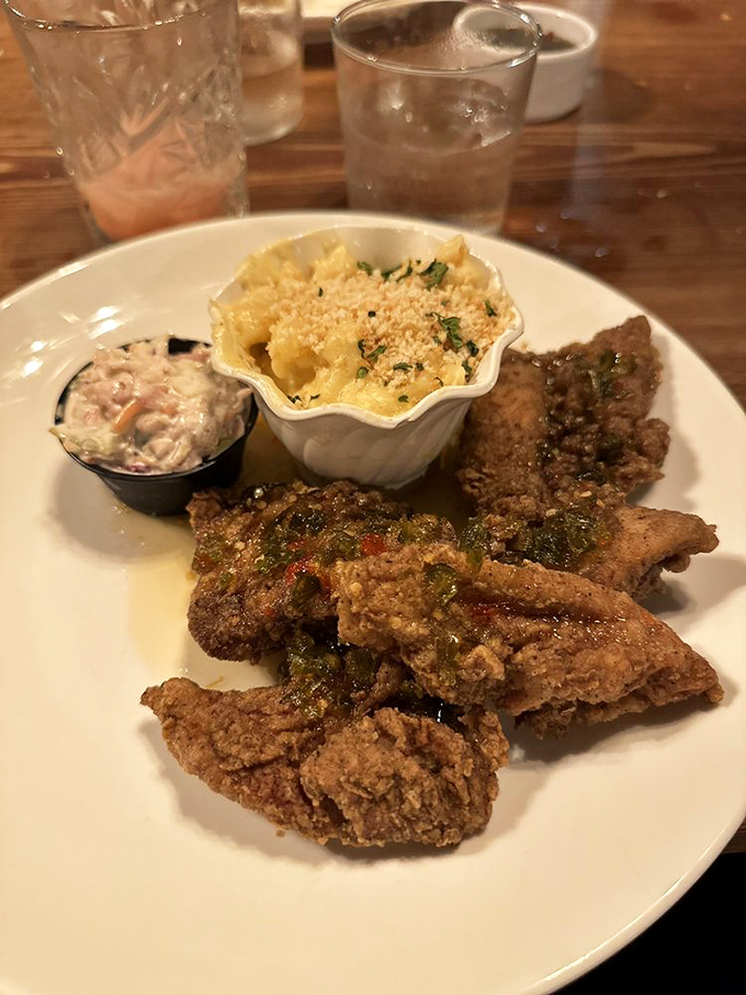 Southern fried chicken arrives golden and glorious, accompanied by creamy mac and cheese that would make any grandmother proudly nod in approval.