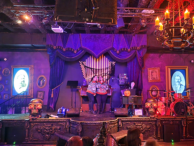 The performance space transforms for special events, with dramatic lighting and vintage-inspired stage design creating the perfect spooky backdrop.