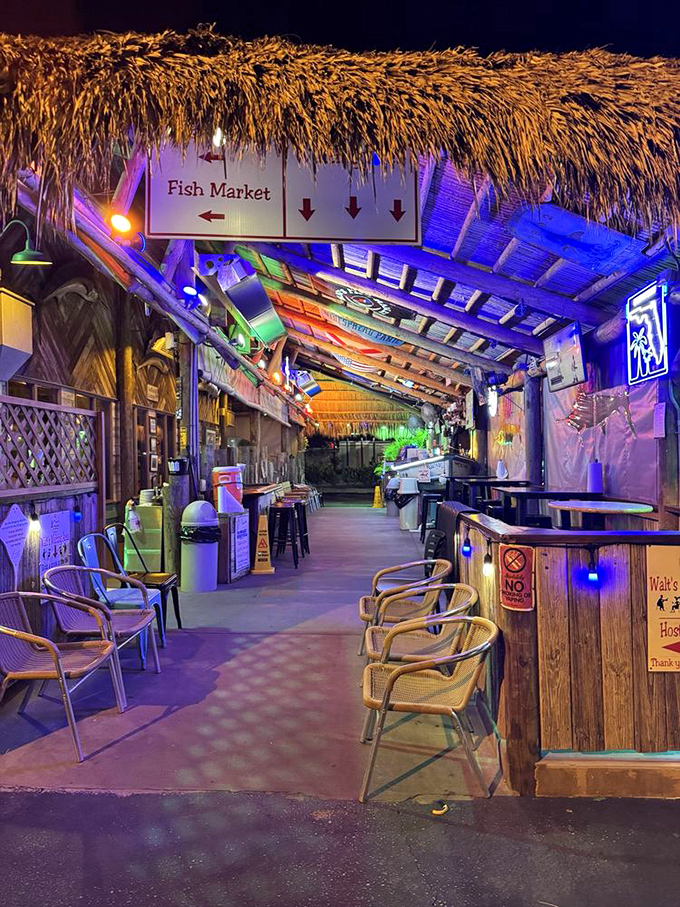 The nighttime waiting area glows with tiki charm. Under those colorful lights, even waiting for a table becomes part of the experience.